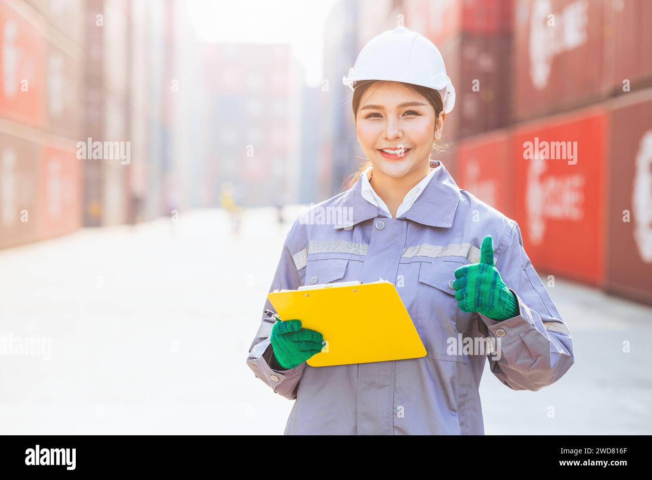 Asian women staff worker in port container yard cargo manager happy ...