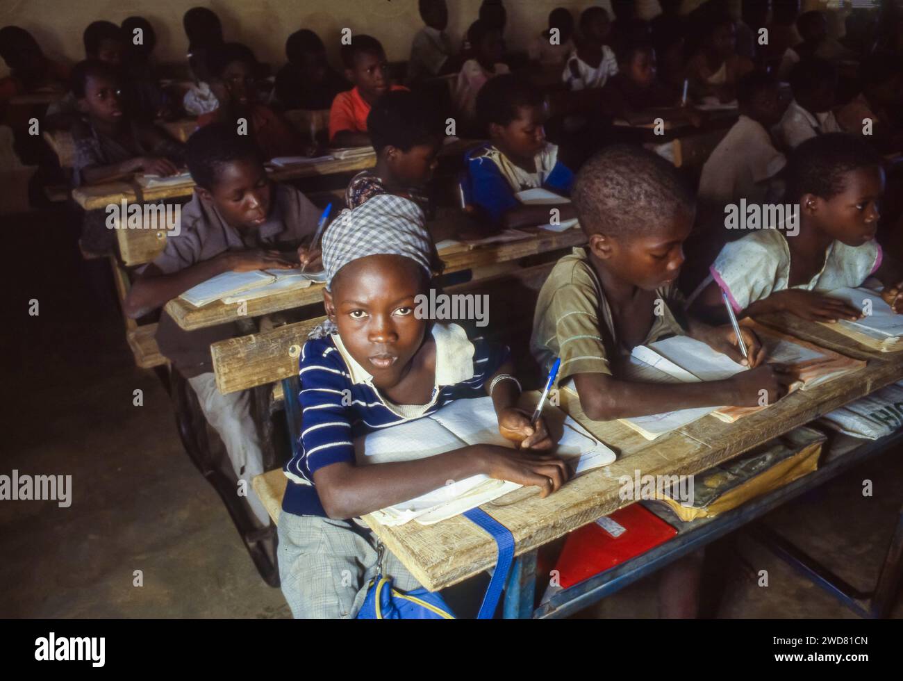 Ivory Coast, Portrait of a girl writing in a notebook at a village ...