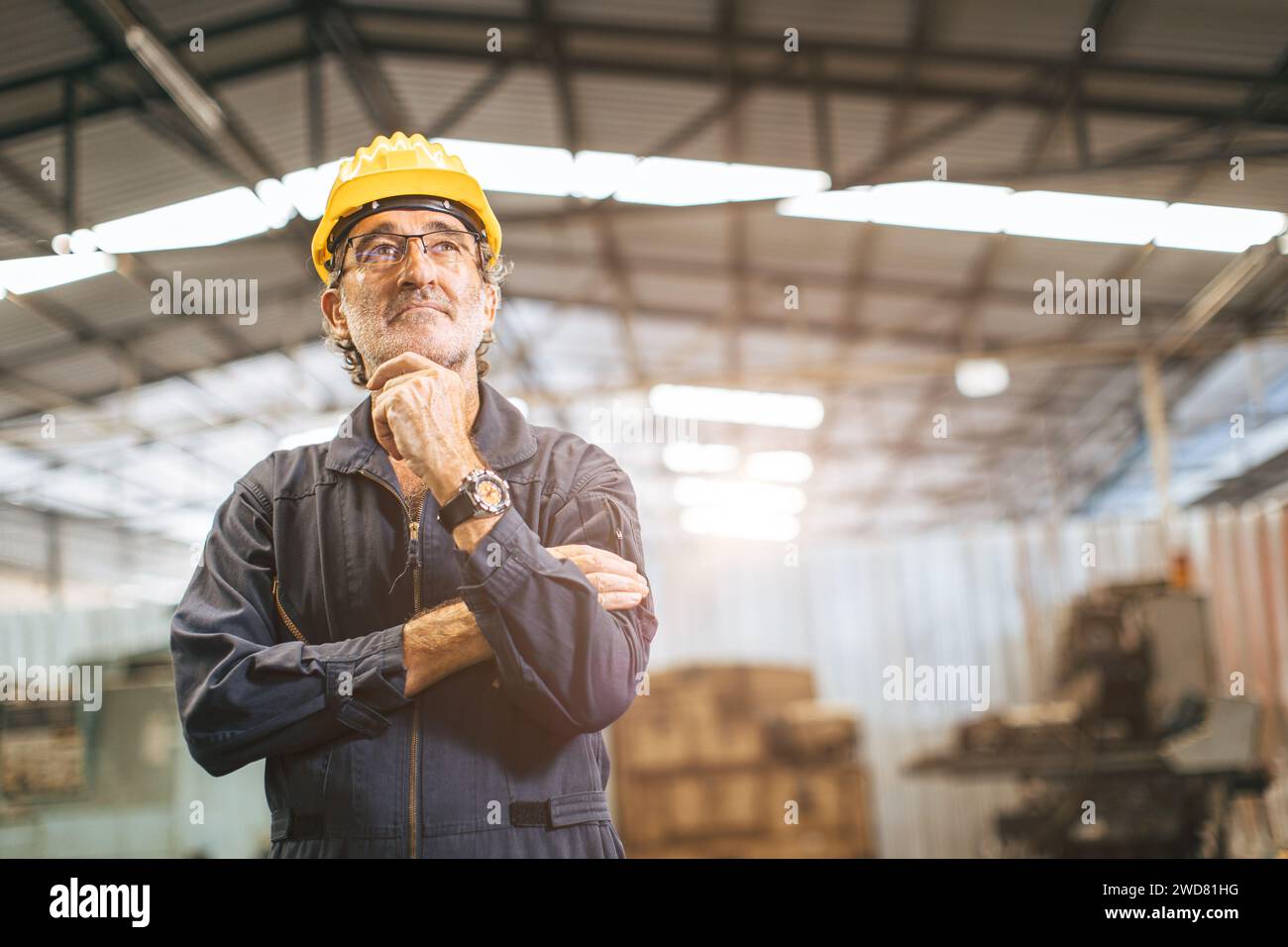 Senior worker engineer male standing thinking in warehouse factory ...