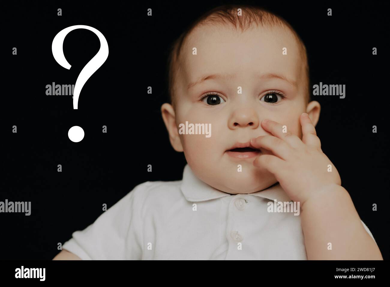 Question mark concept. Surprised questioning little boy on a black ...