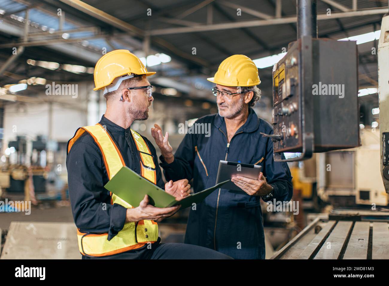 senior supervisor male talking with young new engineer employee ...