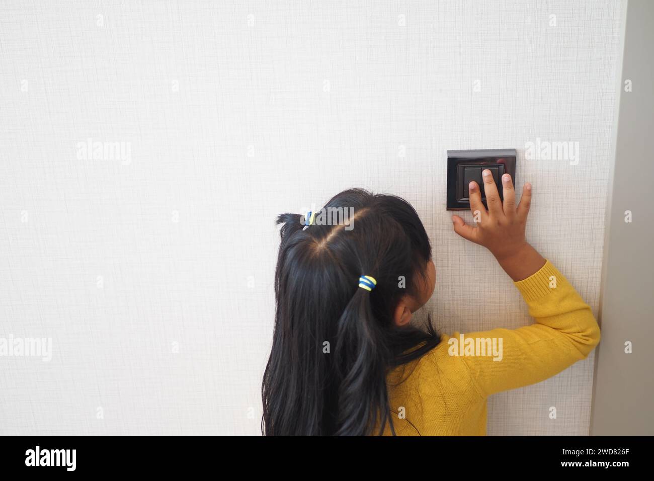 Child turning off light switch hi-res stock photography and images - Alamy