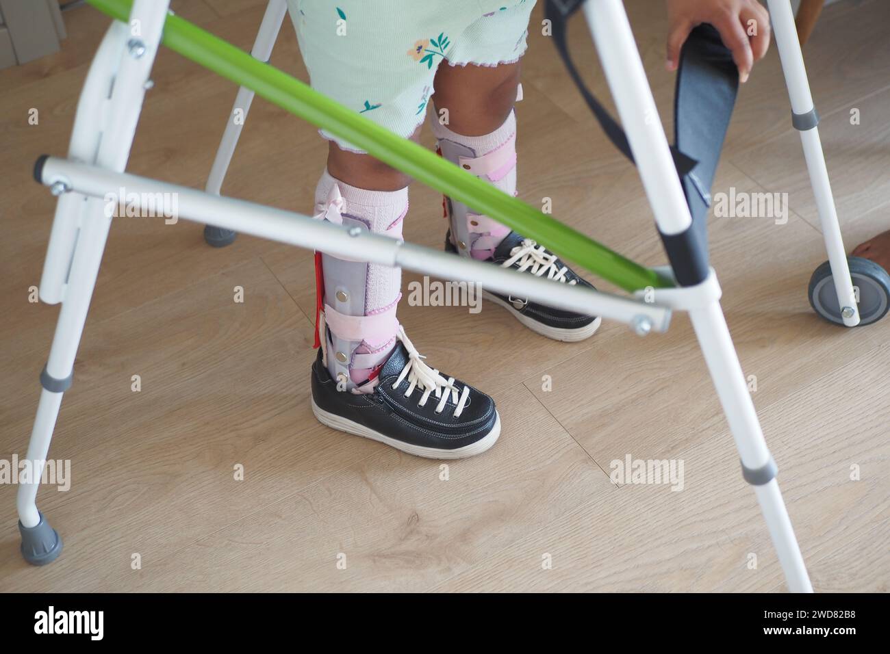 child with walking frame and knee orthosis outdoor Stock Photo - Alamy