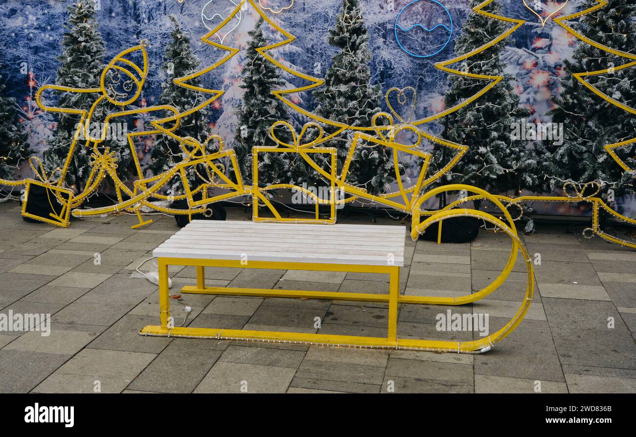 Children's yellow sledges for riding are on the asphalt, snowless ...