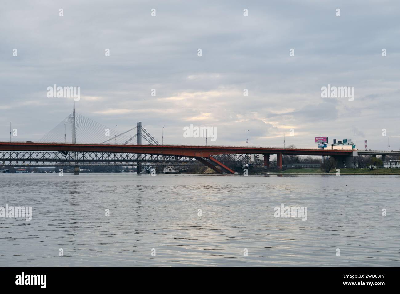 The red iron road bridge over the Sava River. View from the ground from ...