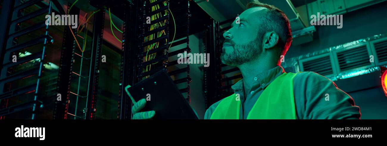 good looking devoted technician in safety clothes working hard holding ...