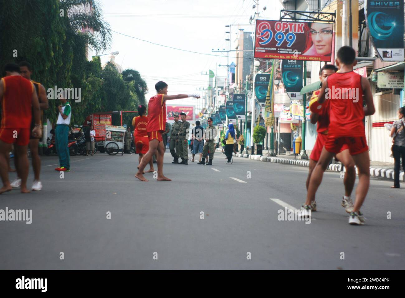 a group of young men practicing boxing on Dhoho Street, Kediri during ...