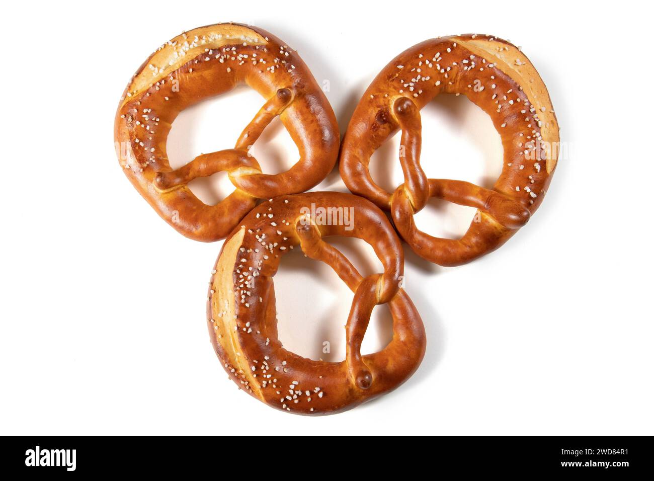 Three Bavarian pretzel top view with salt on a white background. The ...