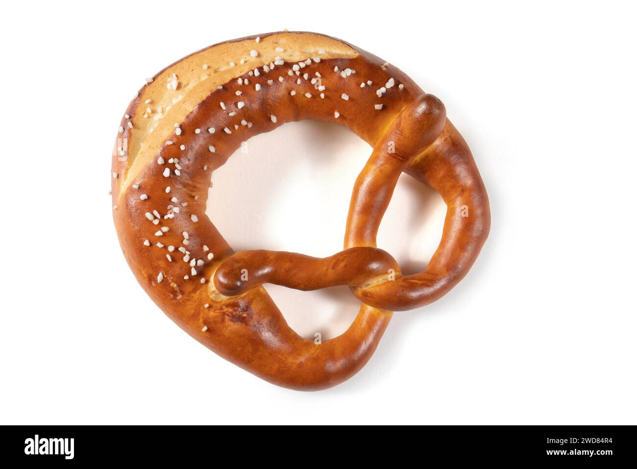 A Bavarian pretzel with salt on a white background. The pretzel is ...
