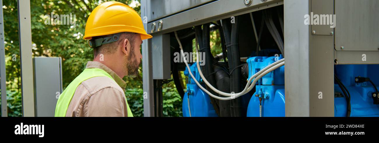concentrated professional in safety clothes and helmet checking outside ...