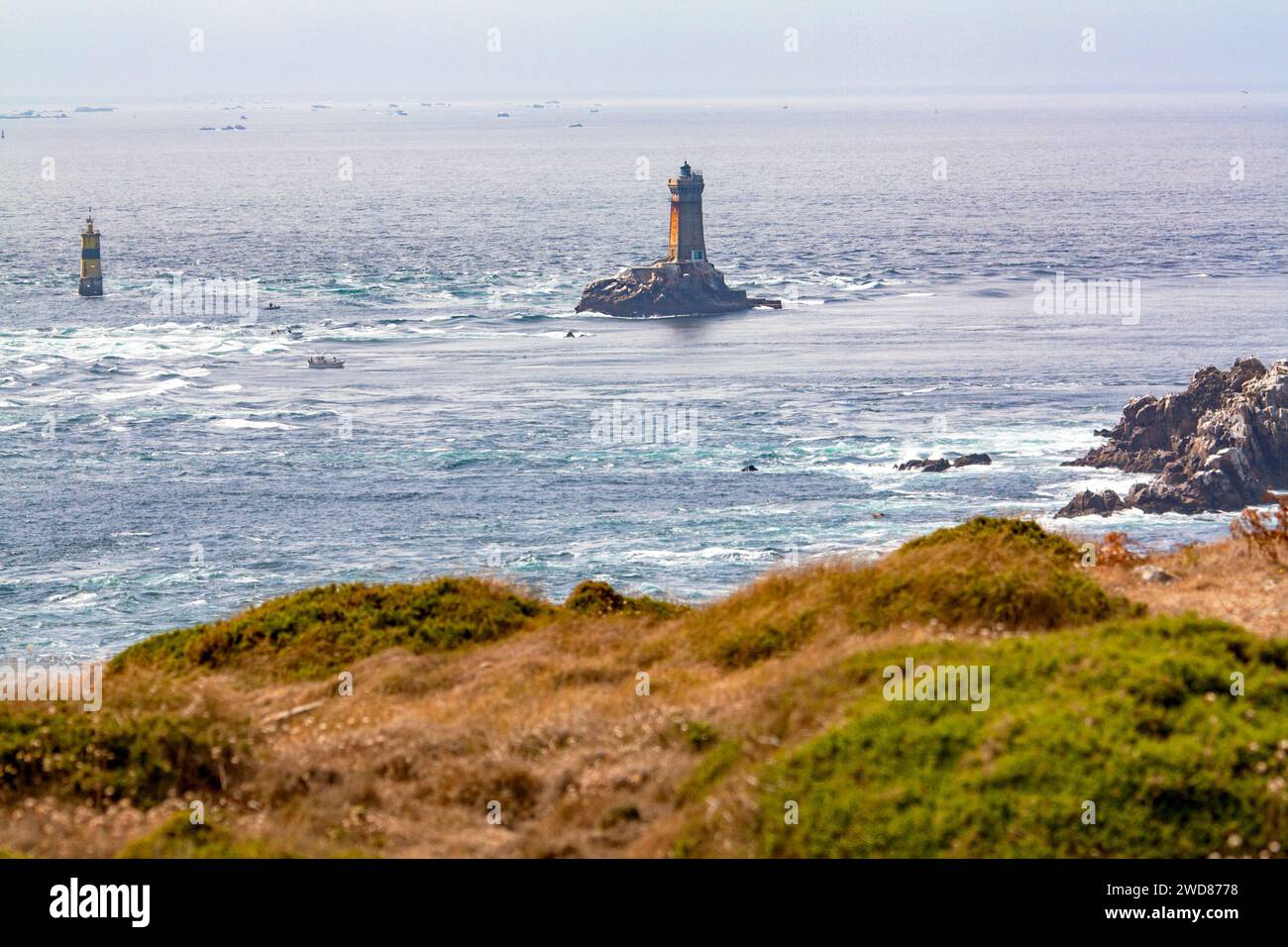 The Pointe du Raz and the Vieille lighthouse in light backlight and sea ...