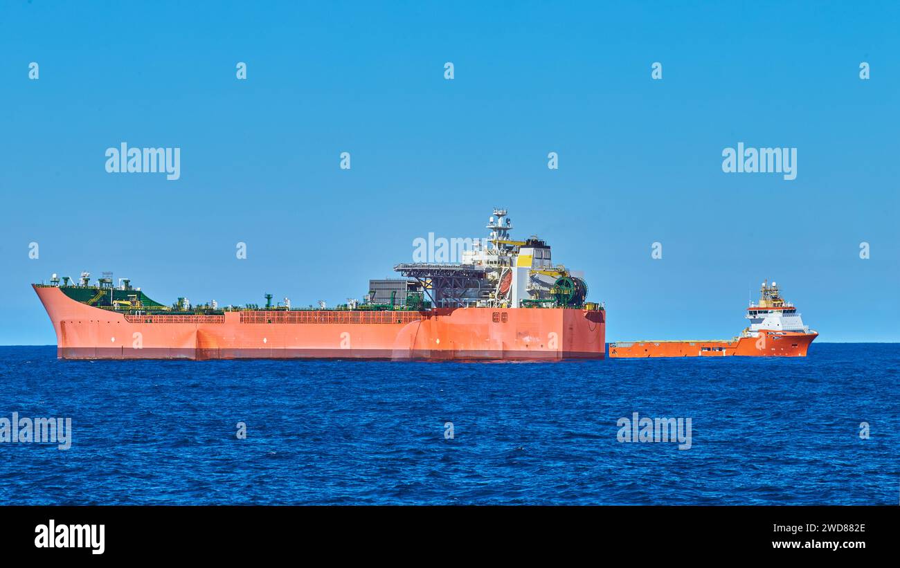 Cargo operations between Fpso tanker and supply vessel in the blue sea ...