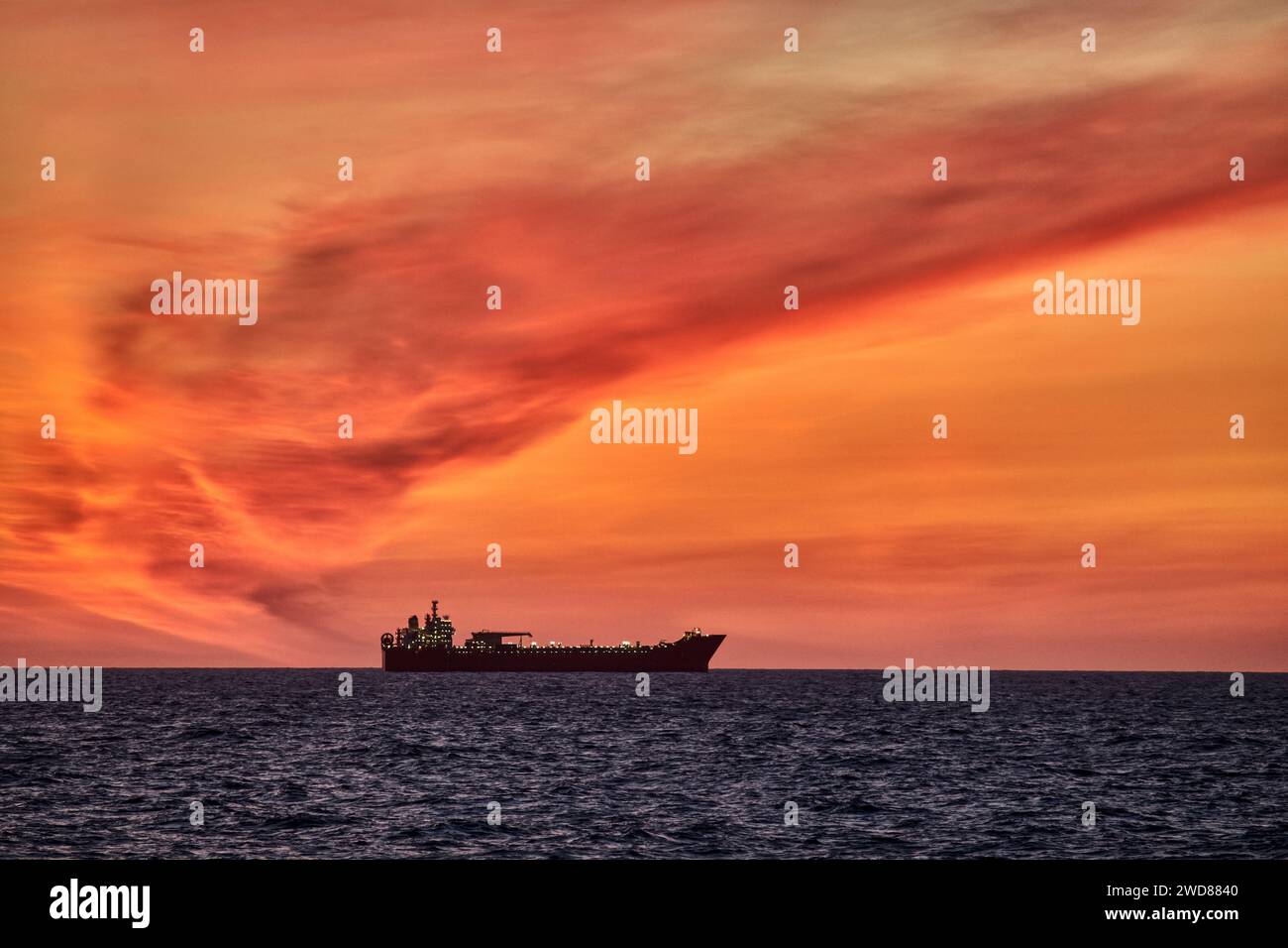 Beautiful ocean sunset , with colourful red and orange sky, dark sea ...