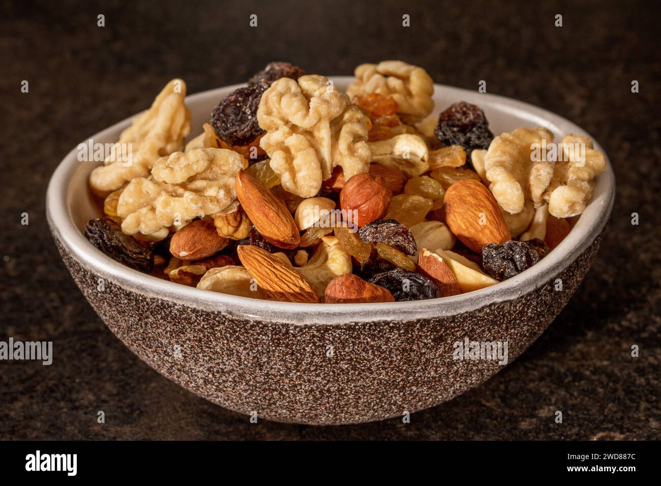 A close-up view of a tempting assortment of mixed nuts and colorful ...