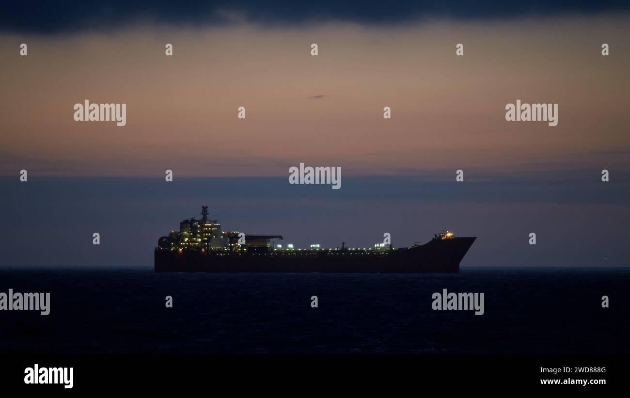 Oil tanker on the horizon in the sea, early in the morning, when the ...