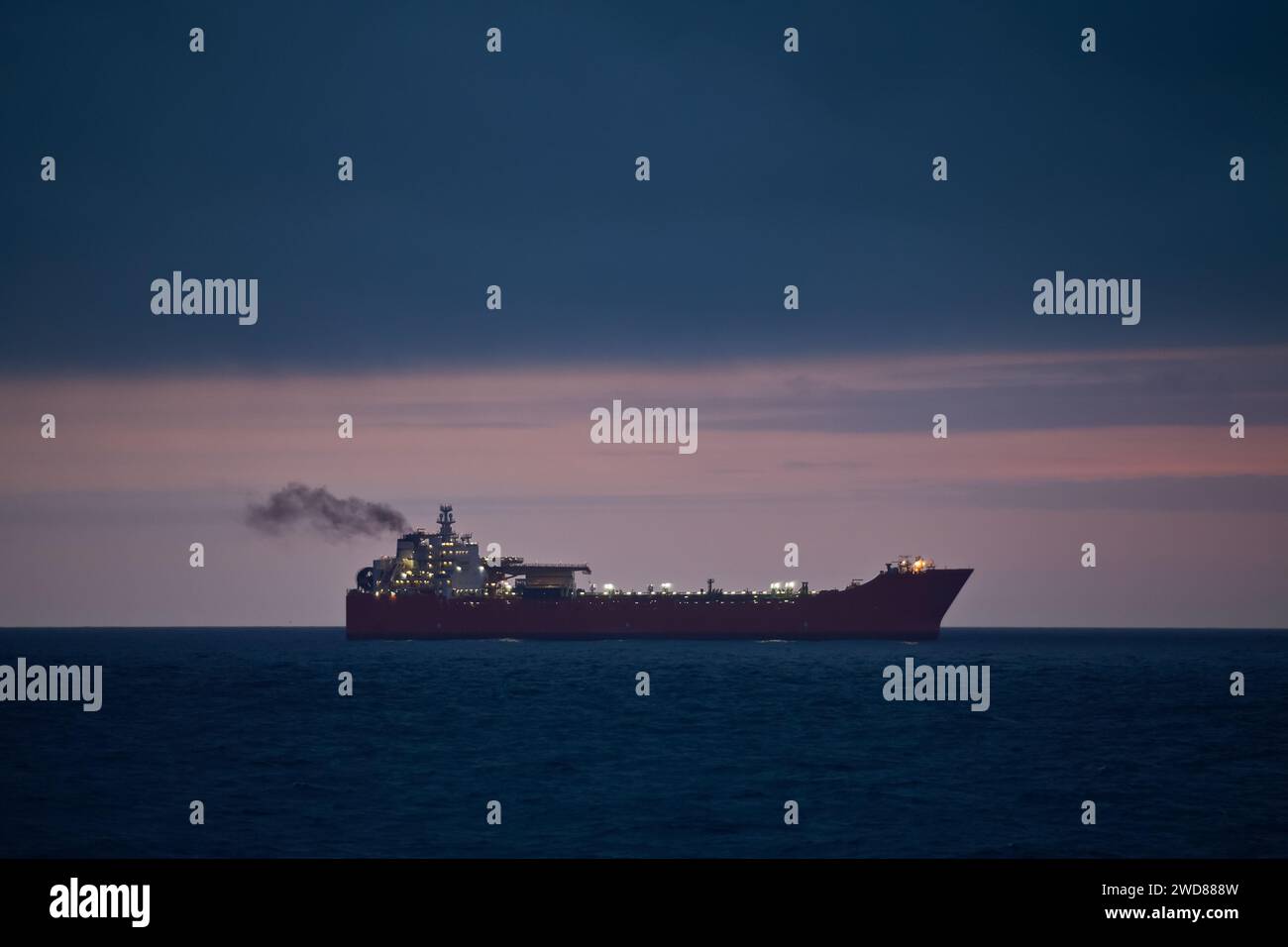 Beautiful ocean sunset, with colourful clouds, dark waves and ...