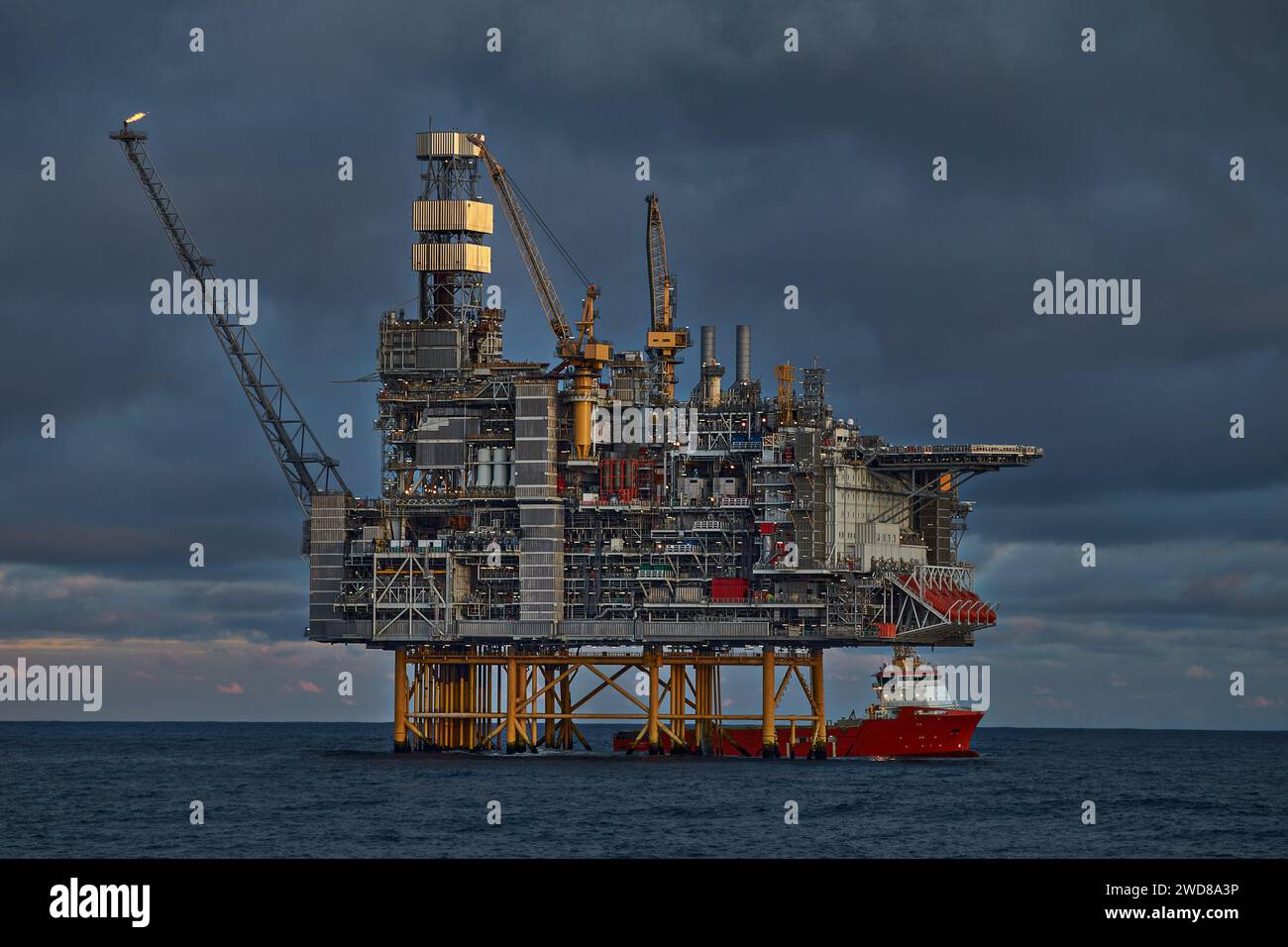 Supply vessel doing cargo operations with jack up drilling rig ...