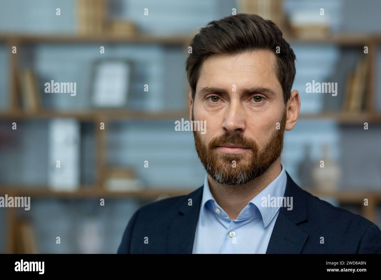 Serious mature businessman with beard in a home office setting ...