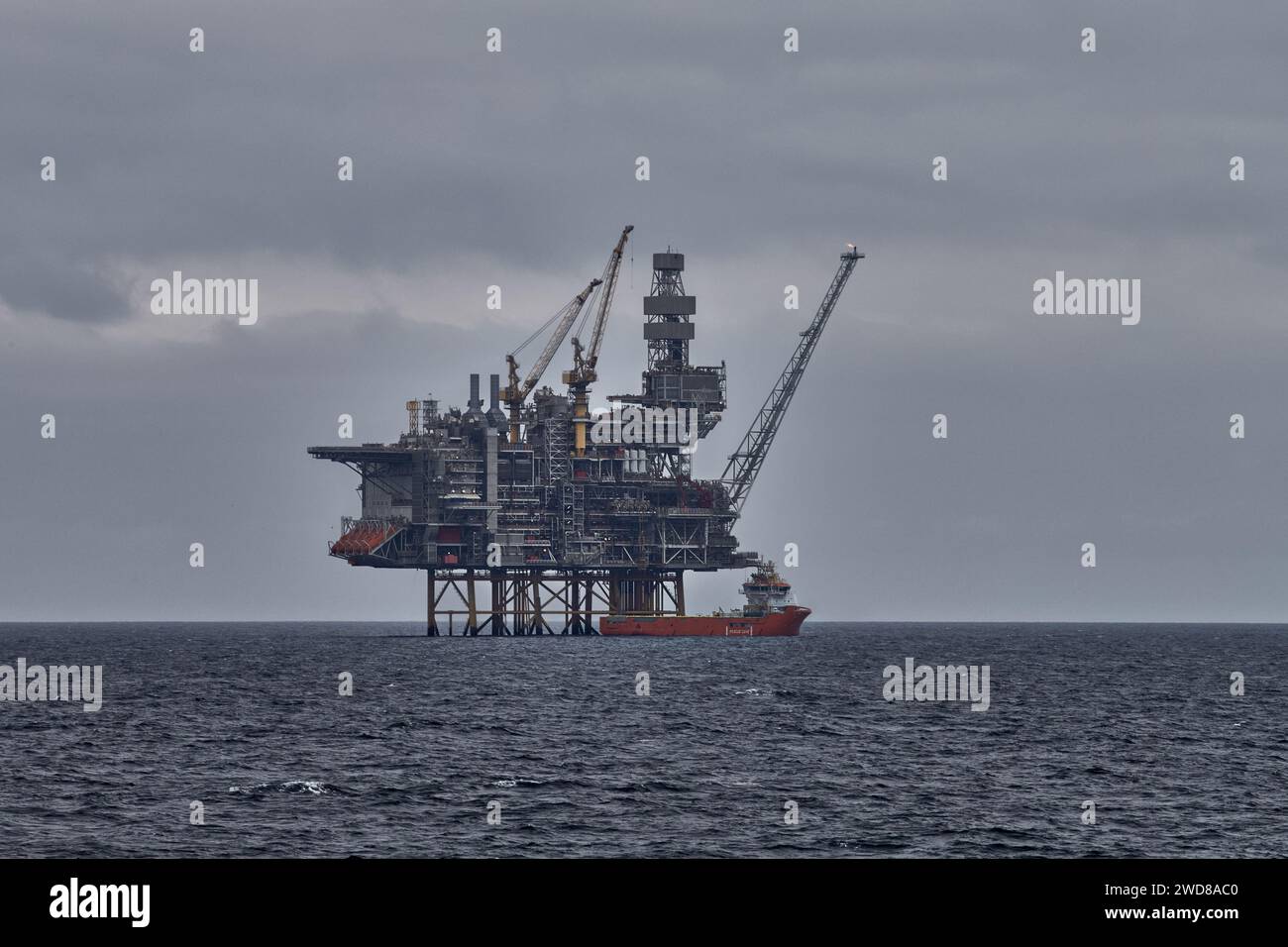 Supply vessel doing cargo operations with jack up drilling rig ...