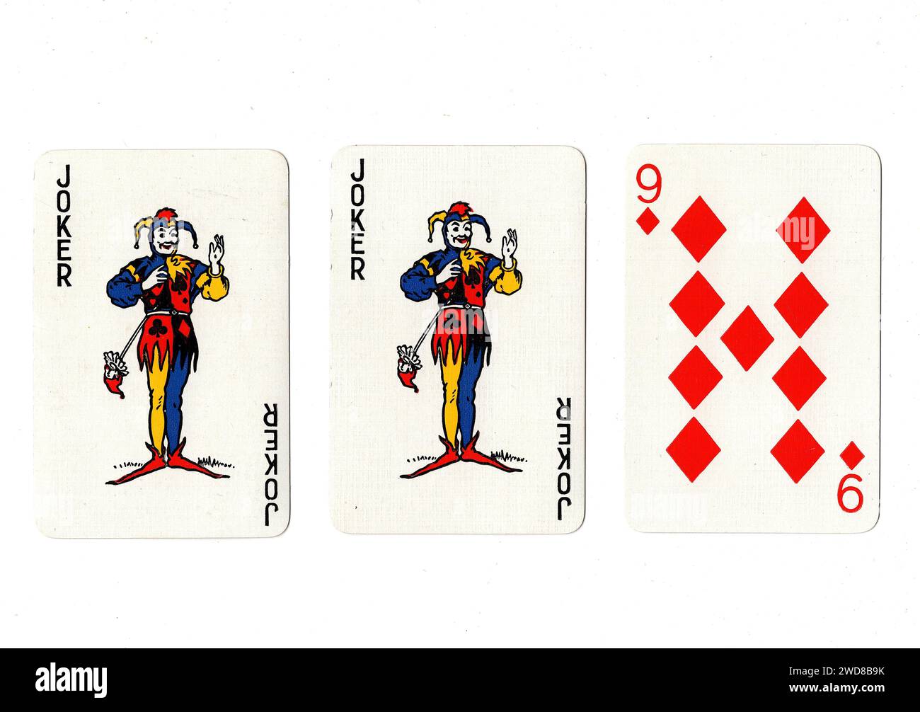 Vintage playing cards showing a pair of jokers and a red nine isolated ...