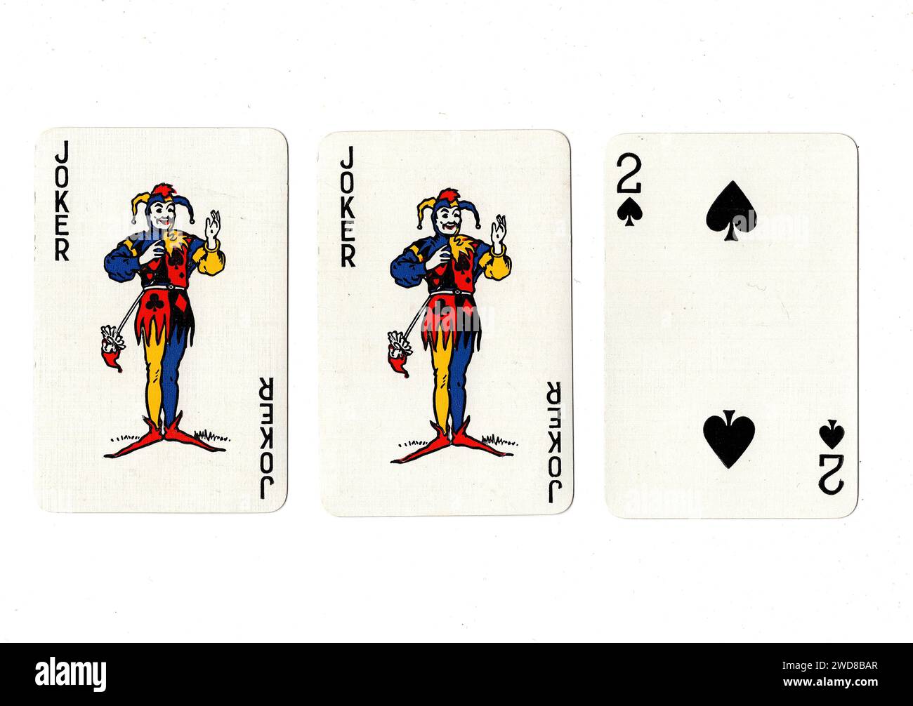 Vintage playing cards showing a pair of jokers and a black two isolated ...
