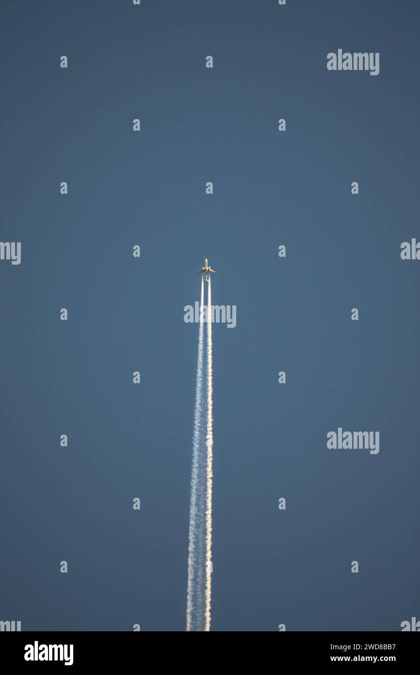 Photo of airplane flying vertically in the clear blue sky, leaving ...