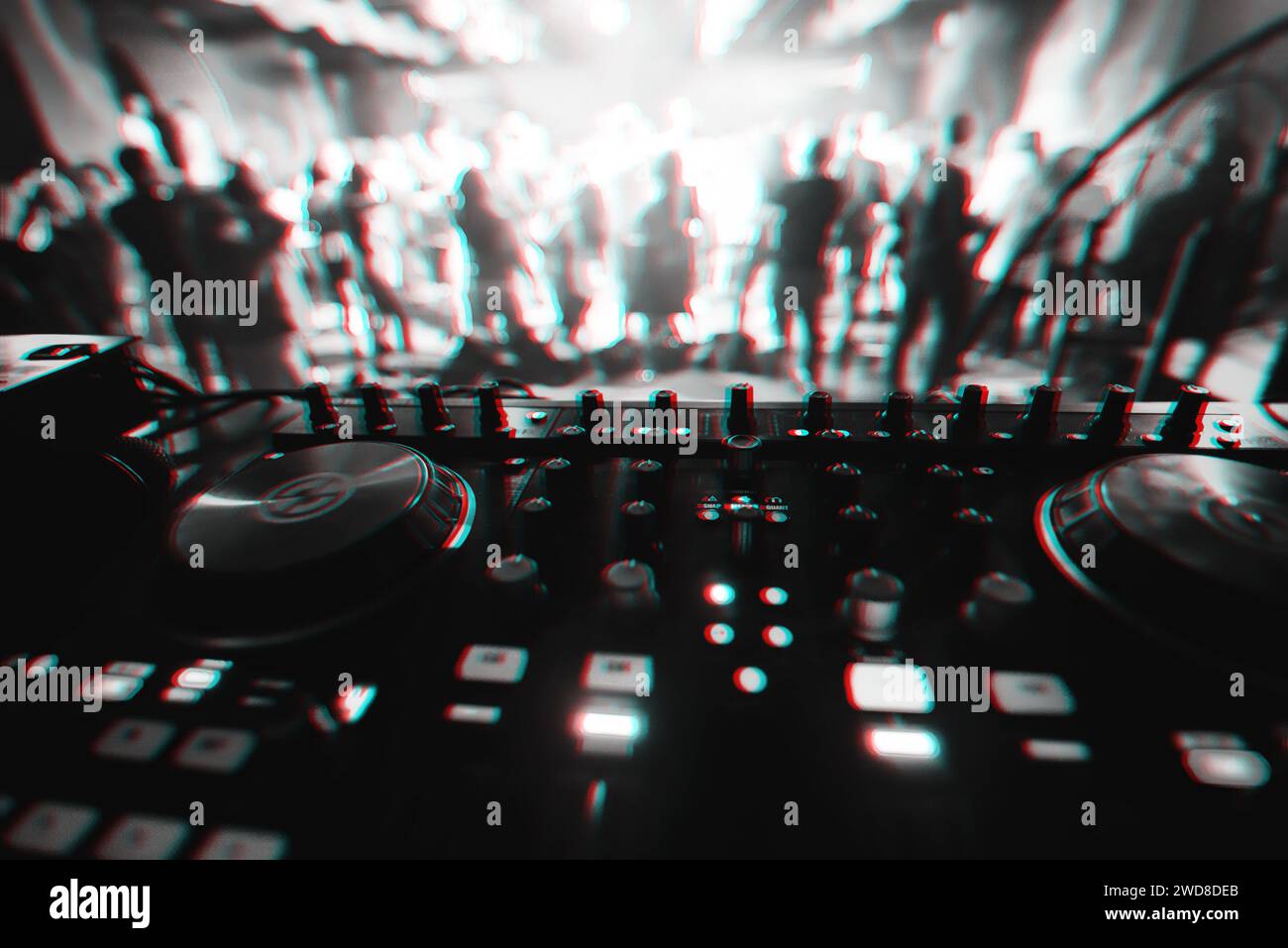 mixer and DJ booth in the nightclub at party c of multi-colored dancers ...