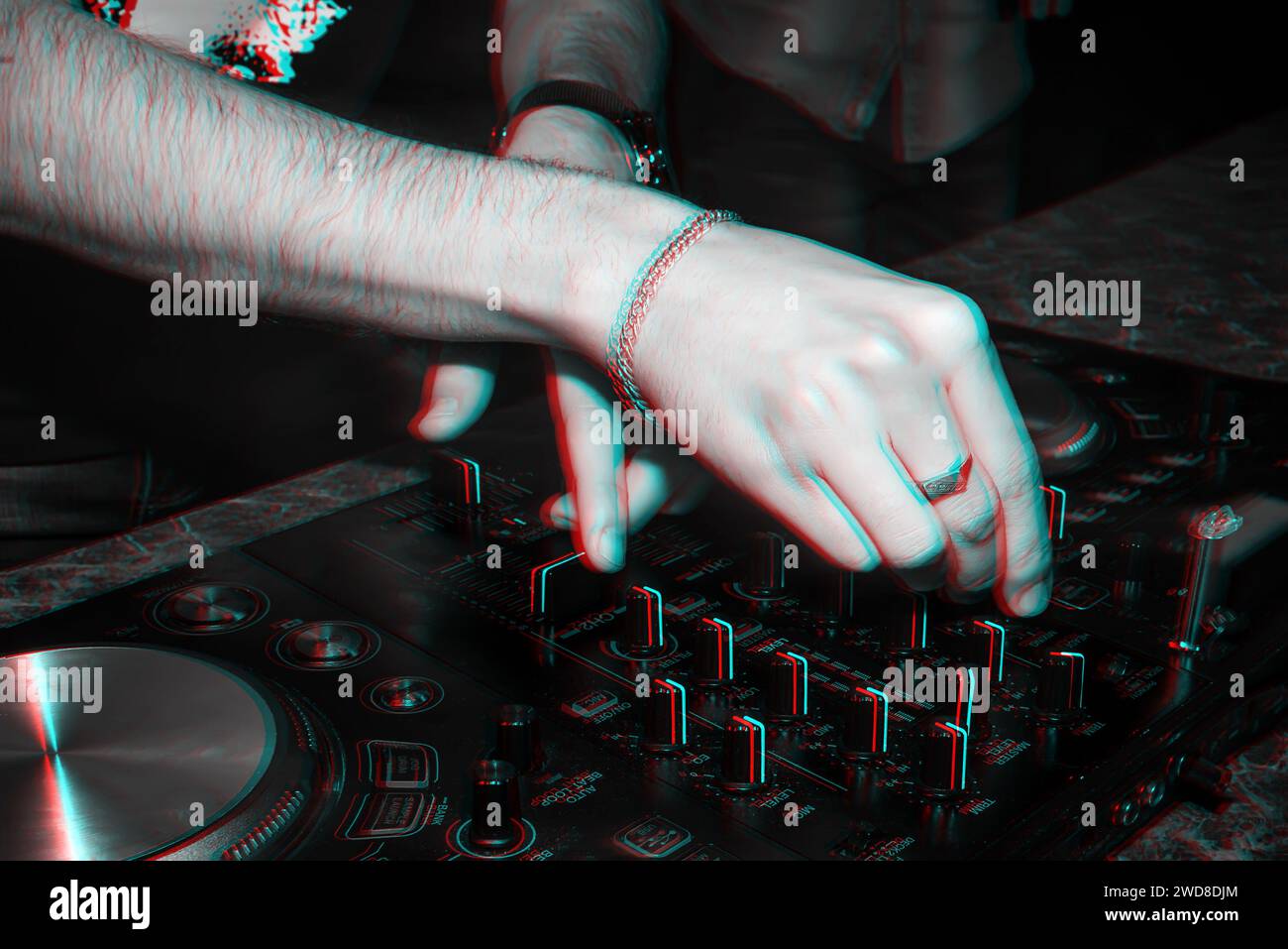 Hands DJ playing music on a professional mixer Board in a nightclub at ...