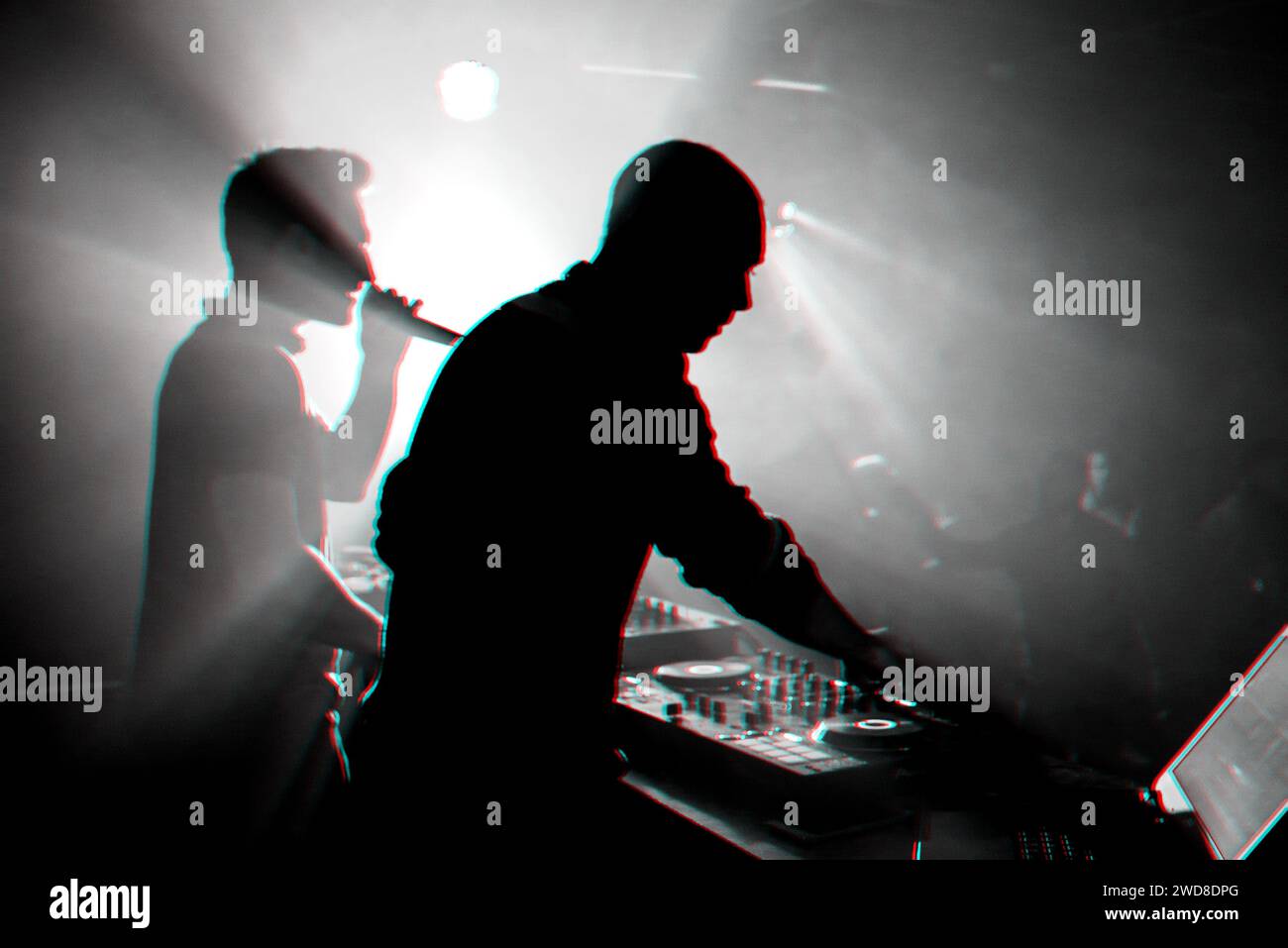 DJ performs in a nightclub and plays electronic music. Black and white ...