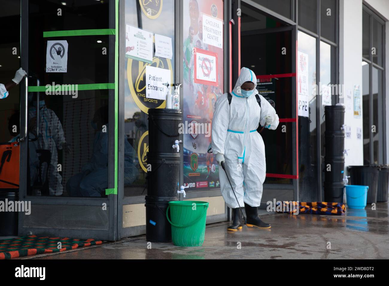 Lusaka, Zambia. 18th Jan, 2024. A health worker sprays disinfectant at ...