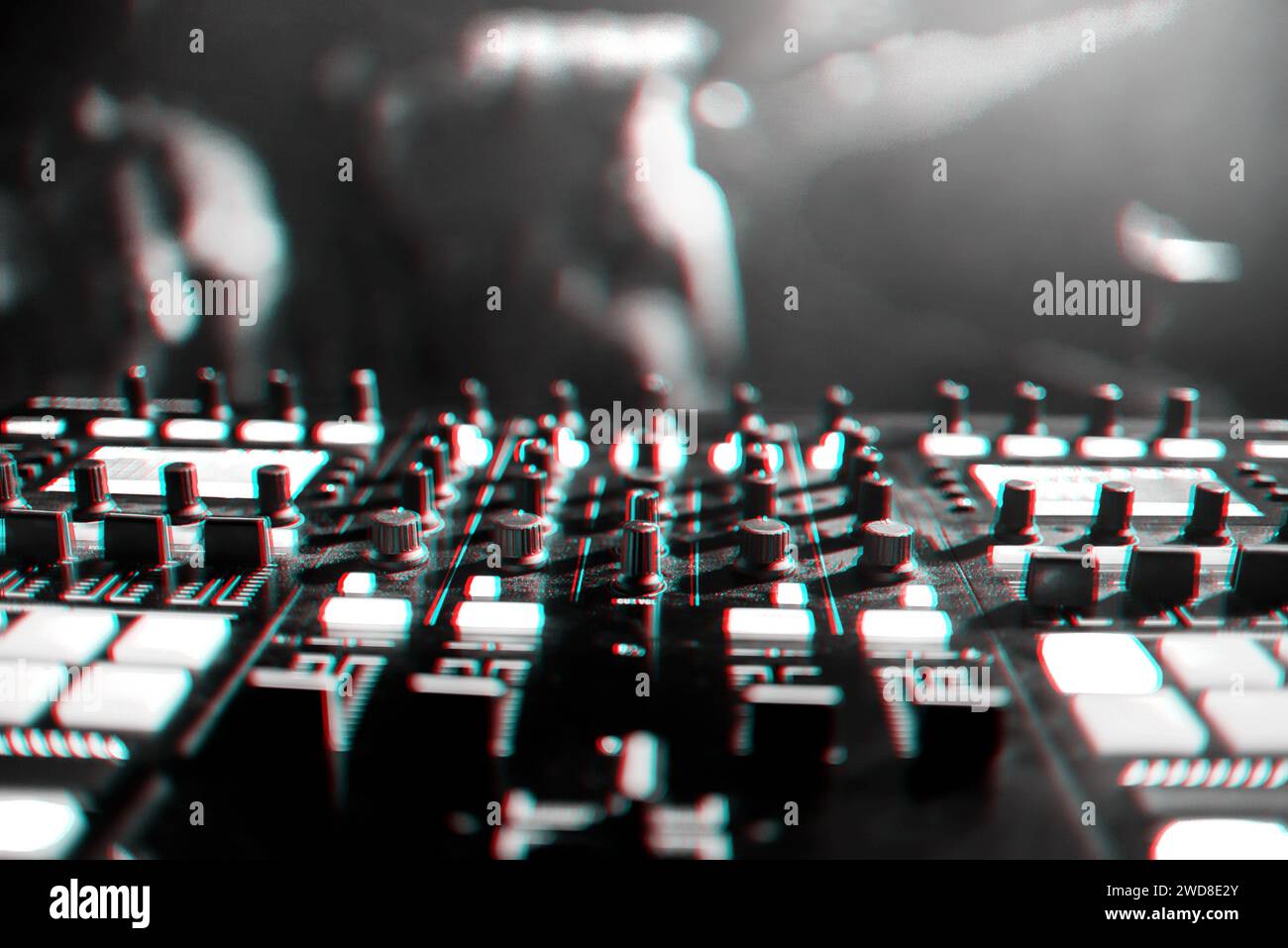 DJ mixer on the table background the night club and dancing people ...