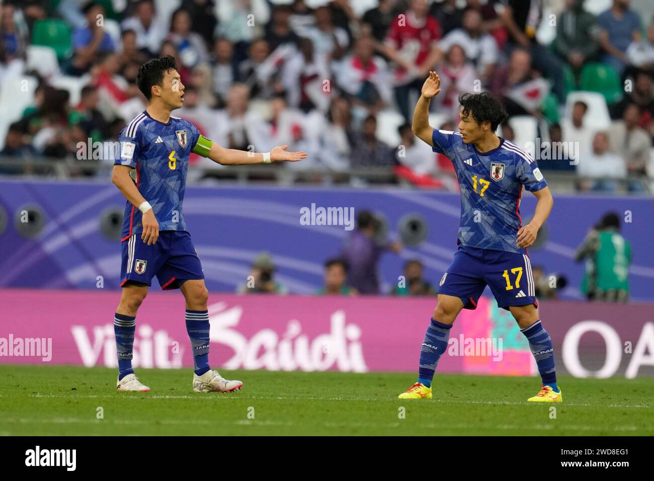 Japan's Wataru Endo, left, reacts after scoring his side's first goal ...