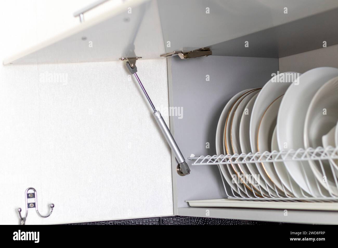 Shot of the gas strut for kitchen cabinet Stock Photo - Alamy