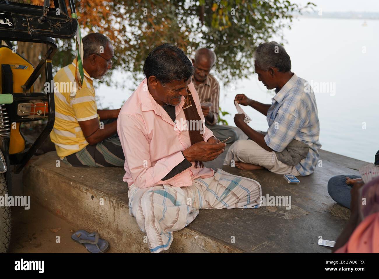 Playing cards by locals beside the Ganges. Uluberia, Howrah, West ...