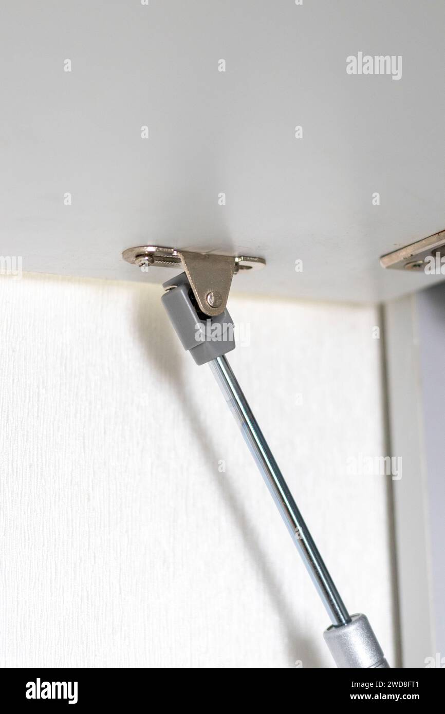 Shot of the gas strut for kitchen cabinet Stock Photo - Alamy