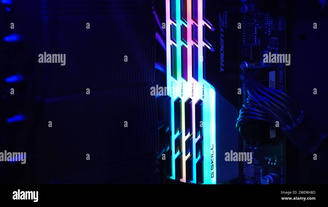 A motherboard with glowing in rainbow RAM memory, gaming-style Stock ...