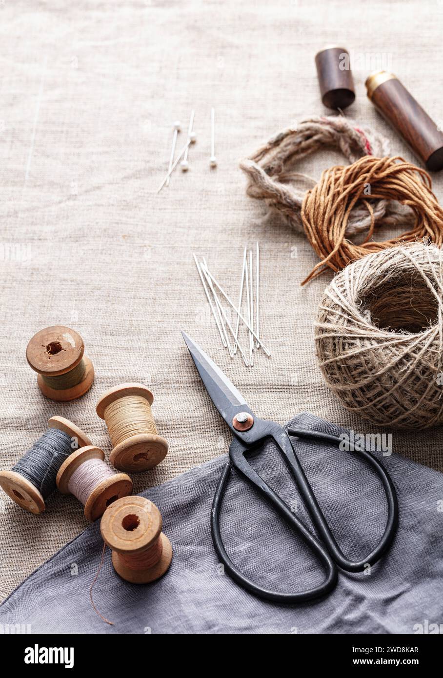 Scissors and spools of thread with a needles on a canvas Stock Photo ...