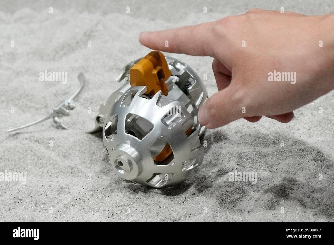 A member of staff shows a real size model of the palm-sized Lunar ...