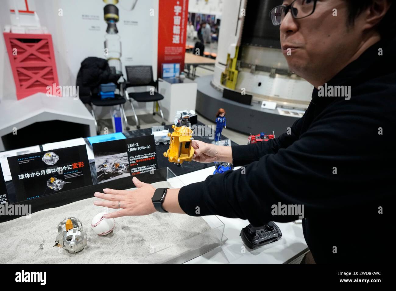 A member of staff shows a real size model of the palm-sized Lunar ...
