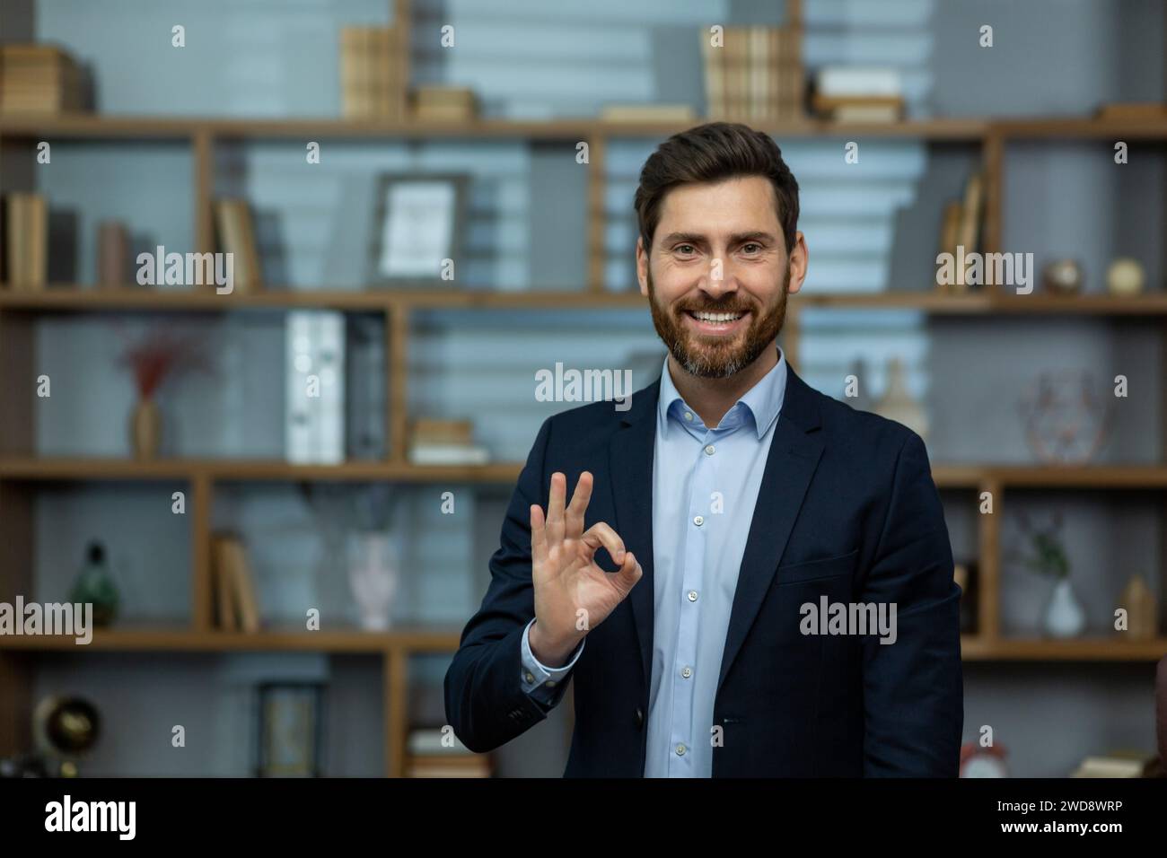 Professional mature male business owner showing positive approval with ...