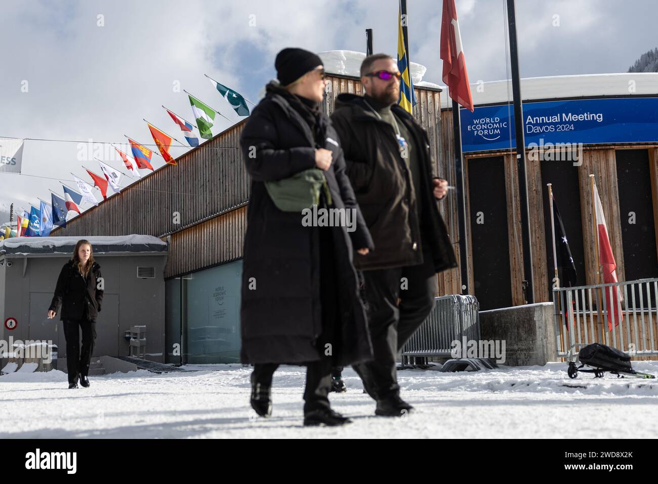Davos, Switzerland. 19th Jan, 2024. People walk in front of the World ...