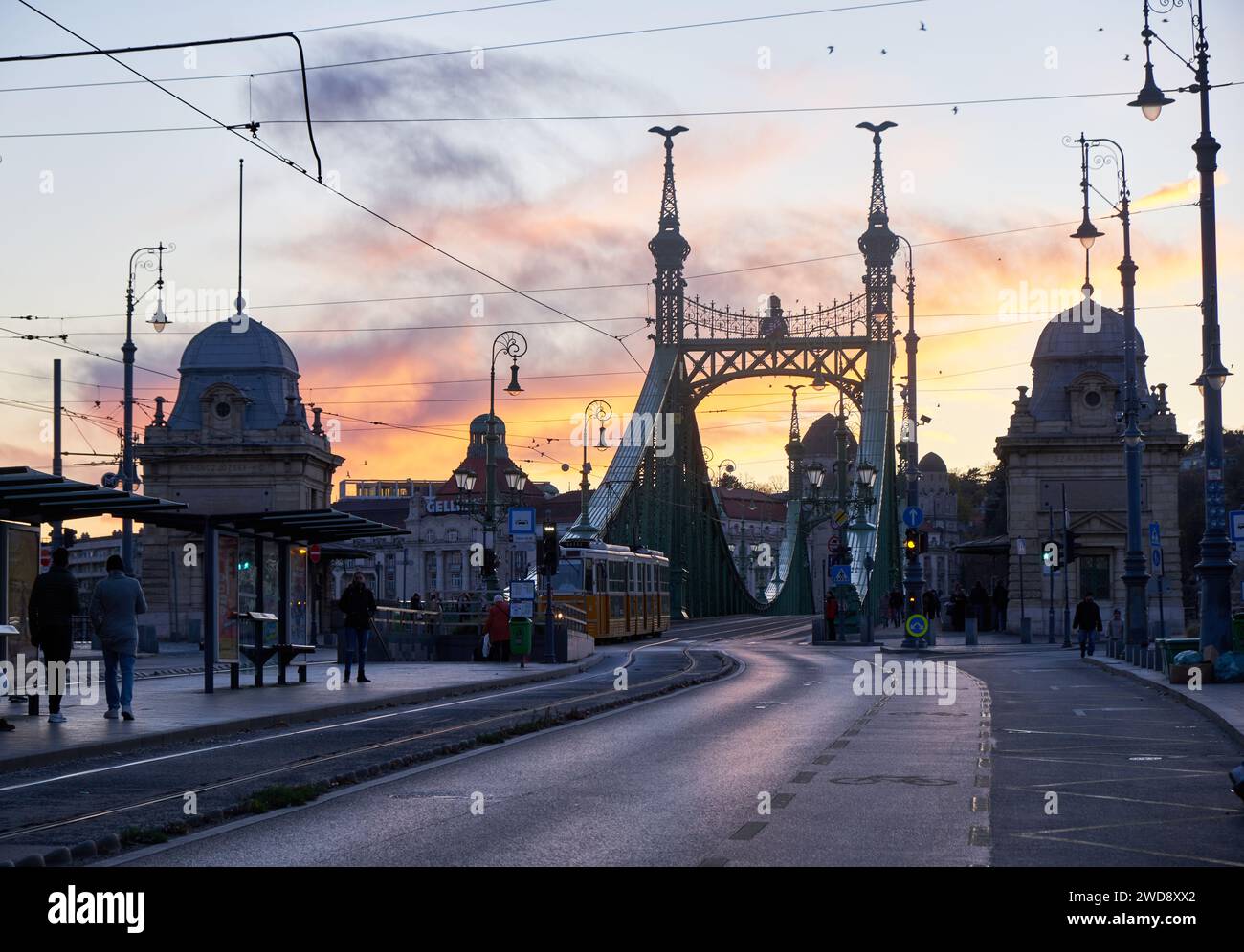 Iron Green Bridge in Budapest at sunset, capturing the tramway and its ...