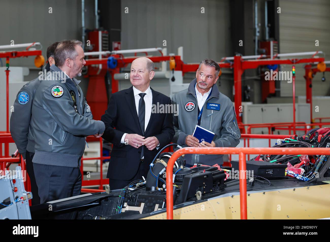 Manching, Germany. 19th Jan, 2024. Chancellor Olaf Scholz (SPD, center ...
