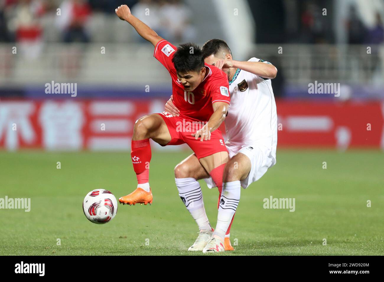 Vietnam's Pham Tuan Hai is fouled by Indonesia's Sandy Walsh, right, during the Asian Cup Group ...