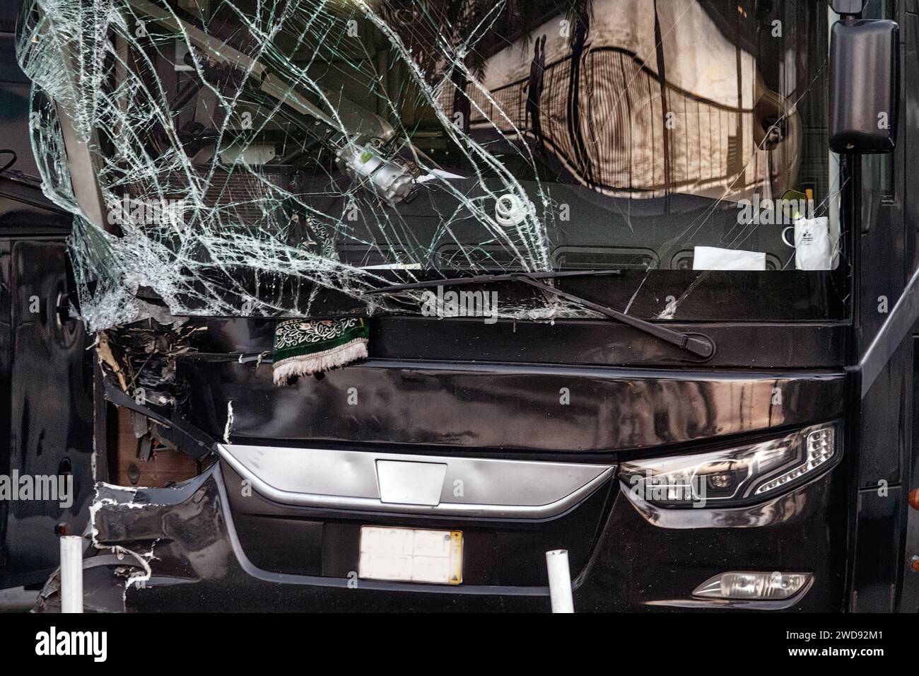 A road accident. The large windshield of the bus was shattered but not ...