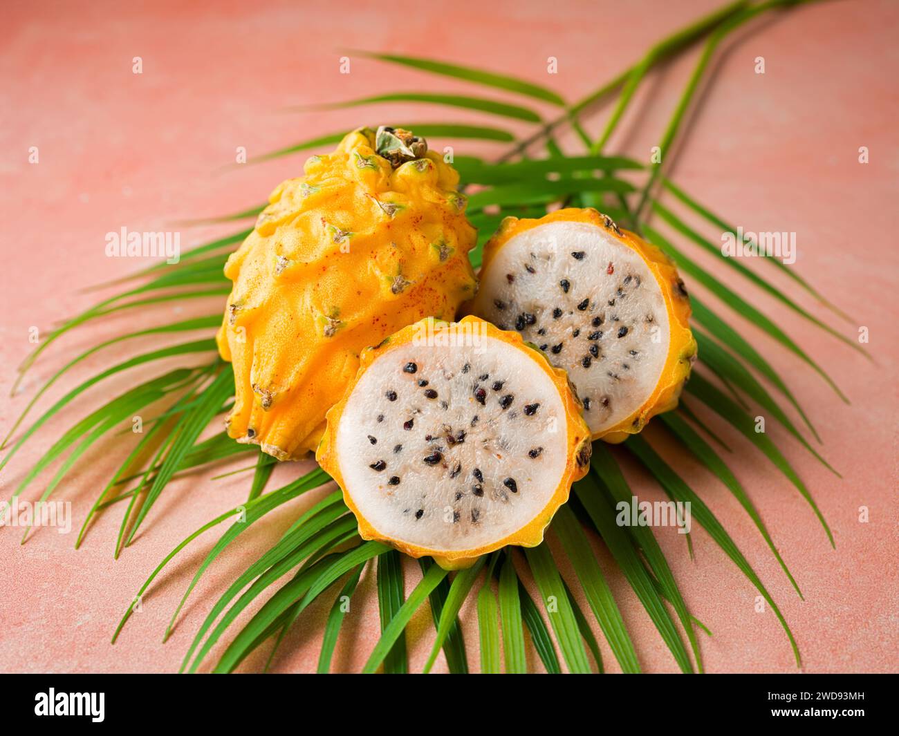 Yellow dragon fruit on palm leaves with copy space Stock Photo - Alamy