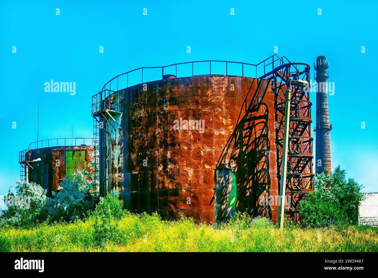 Old rusty oil tanks (fuel reservoir, oil barrel). Evidence of economic ...