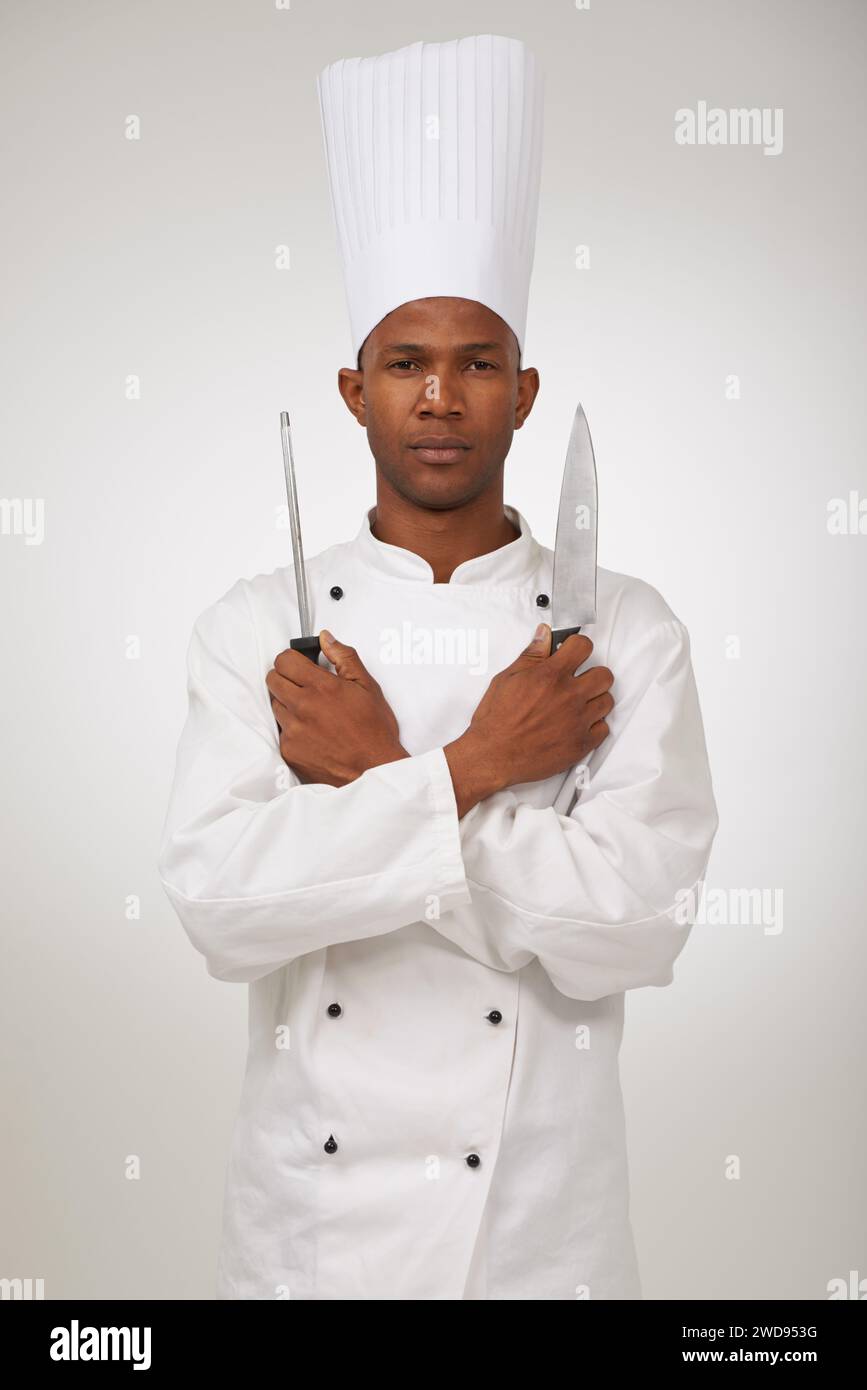 Portrait, african chef and knives in studio in hospitality career and ...