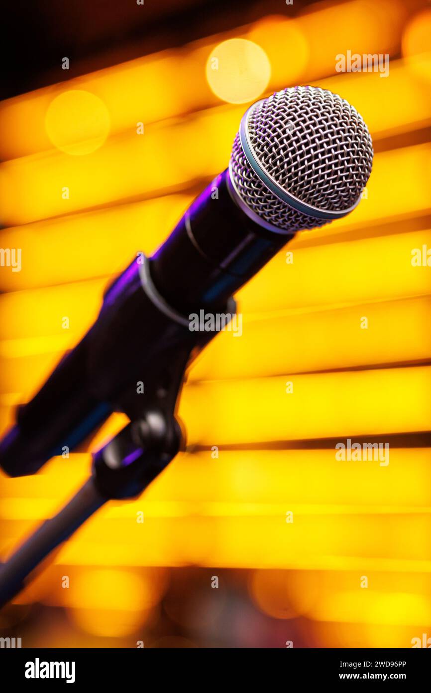 Close-up of a microphone on the stage with club light background Stock ...