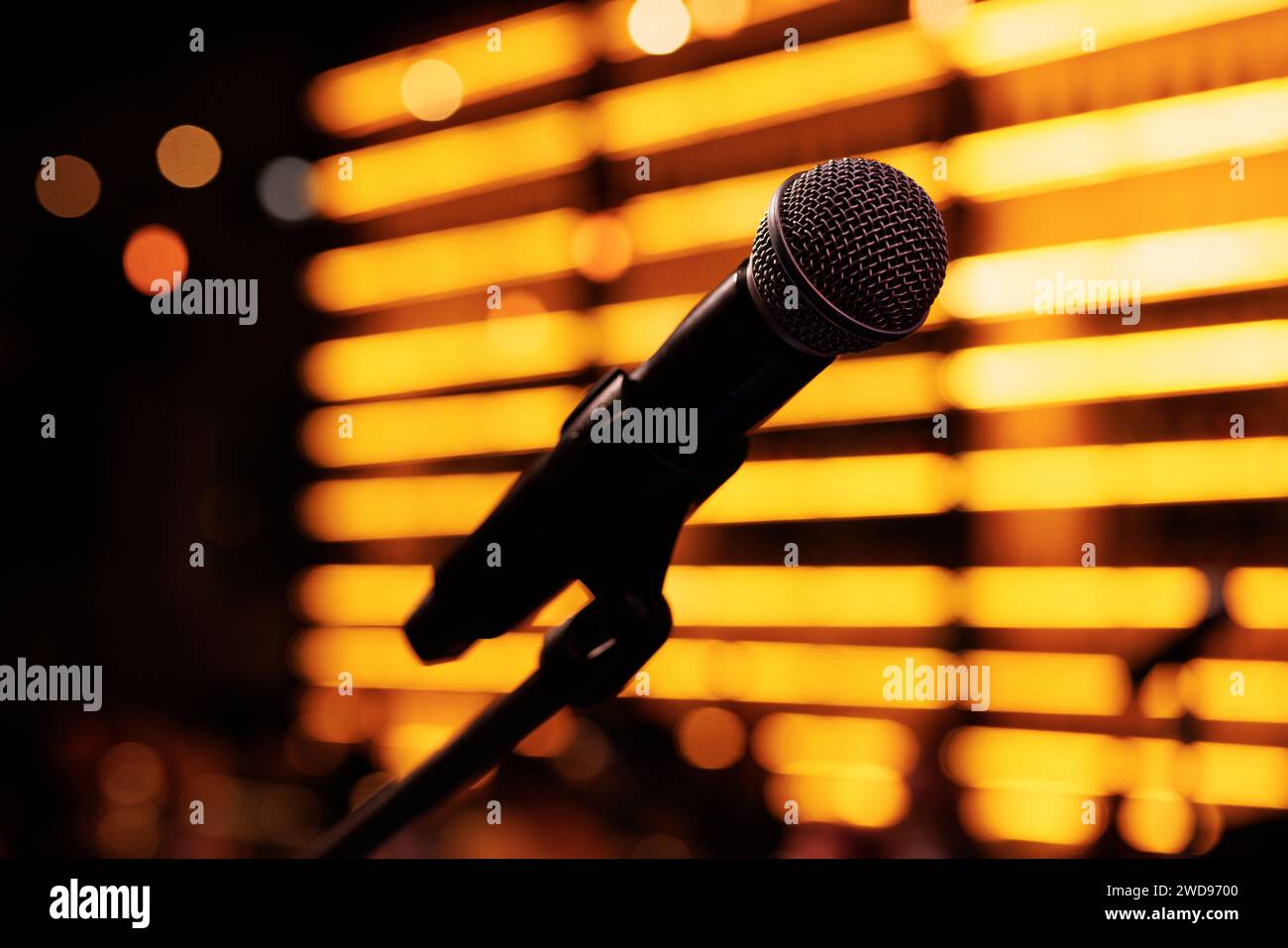 Close-up of a microphone on the stage with club light background Stock ...